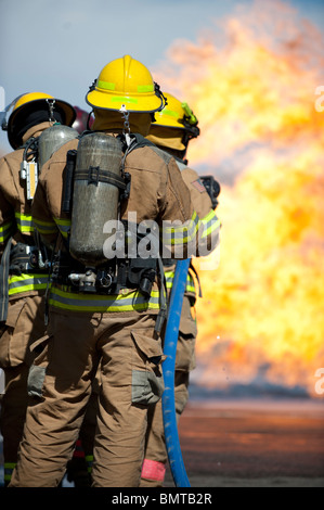 Firefighters prepare to attack a propane fire during a training ...