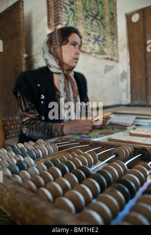 Muslim woman calculate using calculator and invoice bill document with ...