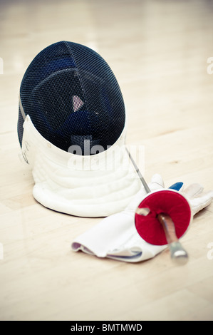 Fencing sword, protective helmet with mask and leather gloves Stock ...