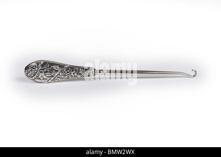 An English button hook with hallmarked Sterling silver handle and steel ...