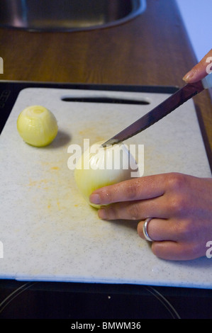 Married woman dicing an onion Stock Photo - Alamy