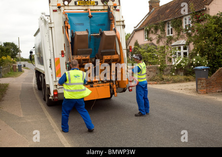 Rubbish collection, bin men working at the back of a lorry, London ...