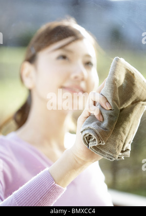 Japanese woman wiping window Stock Photo - Alamy