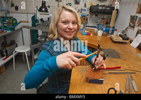 Attractive professional young German Goldsmith Master in her Workshop ...