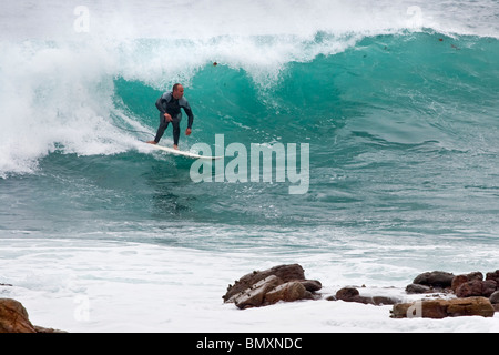 Surfer on a wave at Huzzawouie (Huzzas), a surf break at South Point ...