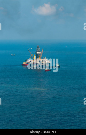 Aerial view of an oil well drilling platform on the tundra at the edge ...