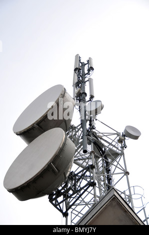 A telecommunication tower with microwave dishes and cell phone Stock ...