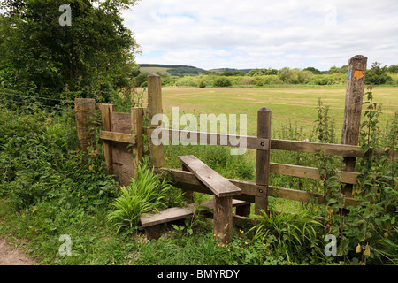 Wooden stile and gate to a country field on a public footpath in West ...