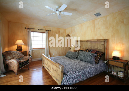 bedroom with double bed with dark wood furniture and balcony with ...