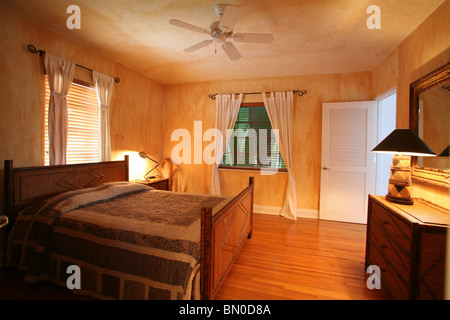 bedroom with double bed with dark wood furniture and balcony with ...