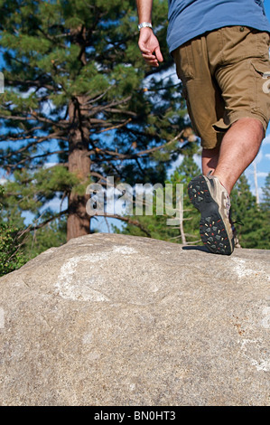 Trail runner climbing a steep rock in his path Stock Photo - Alamy