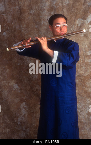 Man playing Dizi or Chinese flute Shiguzhen Yunnan China Stock Photo ...