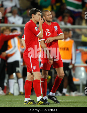 Matt Upson (L) and Gareth Barry (R) of England leave the pitch after ...