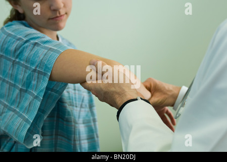 Doctor examining his patient arm Stock Photo - Alamy