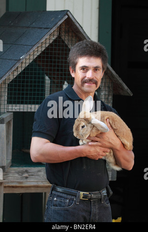 Hispanic man holding rabbit Stock Photo - Alamy