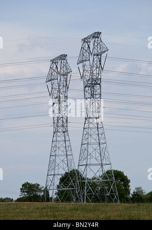 A line of electricity pylons march across the English countryside South ...