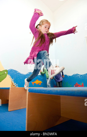 Children jumping over boxes, low angle view Stock Photo - Alamy