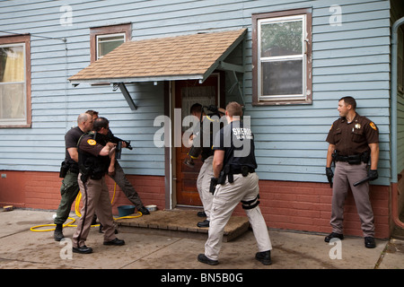 Deputy sheriff's serving drug related search warrant in a rural US ...
