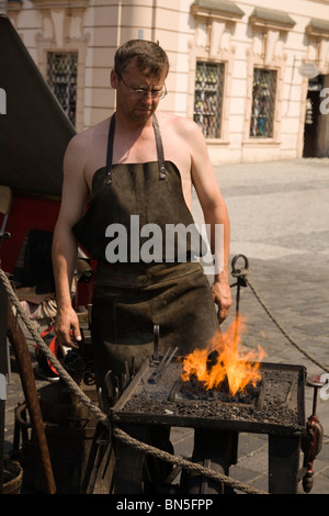 Blacksmith working with a coal fire Stock Photo - Alamy