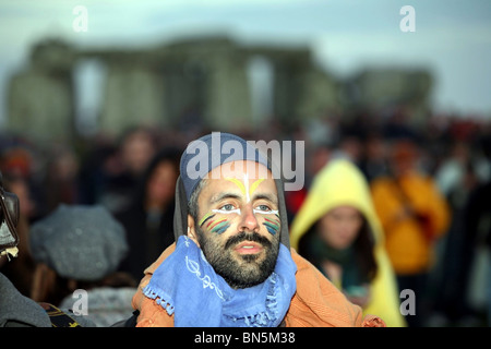 A reveller at the ancient stone circle Stonehenge to celebrate the ...