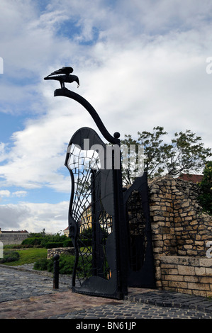 Black metal Corvinus gate with raven holding a golden ring in his beak ...