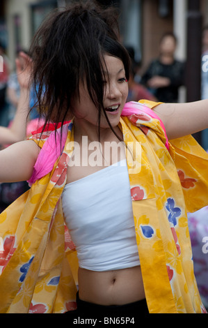 Dancing woman in traditional Japanese kimono on a black background ...