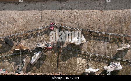 Old running shoes hanging on the anchor chain Stock Photo - Alamy