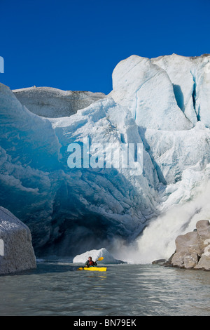 A kayaker explores a melt stream gushing from beneath Mendenhall ...