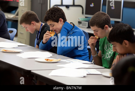 Members of high school student advisory council listen to speaker ...