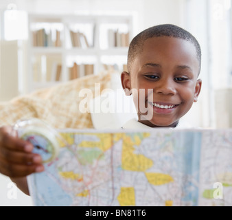 Boy looking at map Stock Photo - Alamy