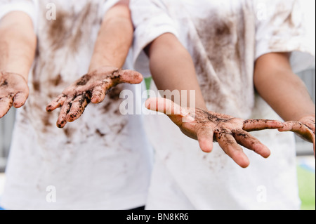 Boys displaying their messy hands Stock Photo - Alamy