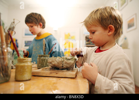 Creative children working with clay at pottery workshop Stock Photo - Alamy
