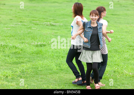 Three Women Holding Arms Standing Back to Back Stock Photo - Alamy