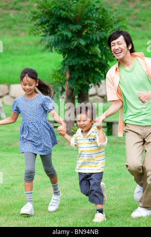 Children running hand in hand Stock Photo - Alamy