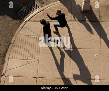 4 men shadows on sidewalk Stock Photo: 17483970 - Alamy