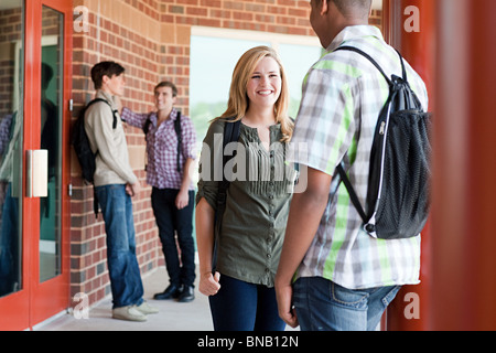 High school student chatting with classmate in art class Stock Photo ...