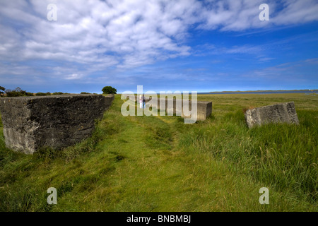 WWII anti tank defense. Blocks of concrete lining the beach head on the ...
