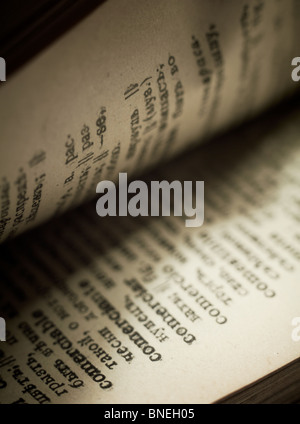 Advantage word on page and paper dollar signs around on wooden table ...