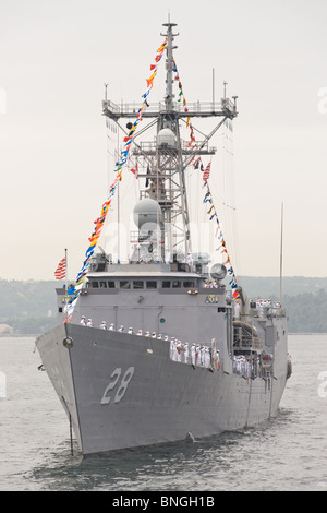 US Navy USS Boone (FFG 28) Sailors handle a line while performing an ...