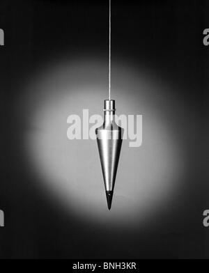Plumb weight hanging on a string Stock Photo - Alamy