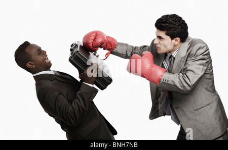 Businessman defending himself from the punch of his colleague Stock ...