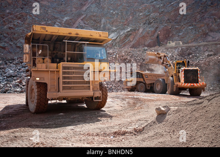 Large earth mover haul dump truck in quarry fully loaded with heavy ...