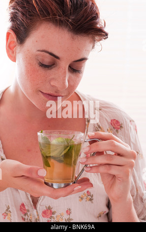 Herbal or Green Tea on white background, top view, copy space. Teapot ...