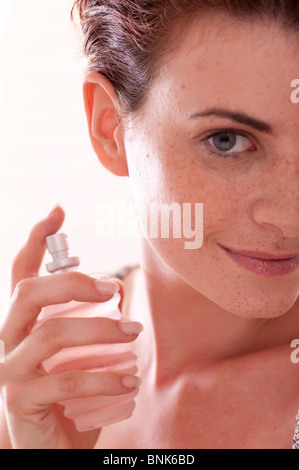 A woman spraying perfume Stock Photo - Alamy