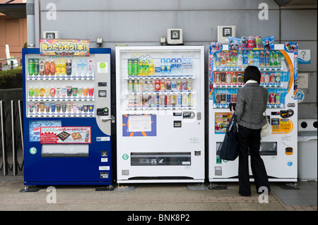 Japan vending machines - Tokyo woman buying drinks. Japanese student or ...