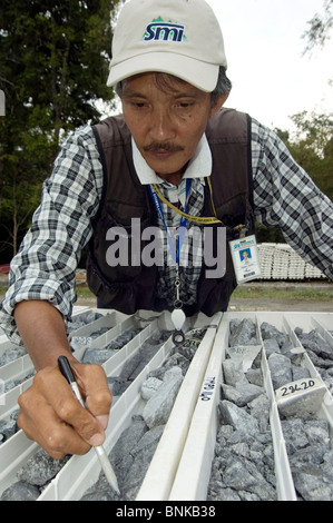 Filipino geologist studies core samples from drilling world's largest ...