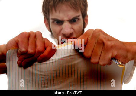 Angry young man ripping trying to papers on white background Stock ...