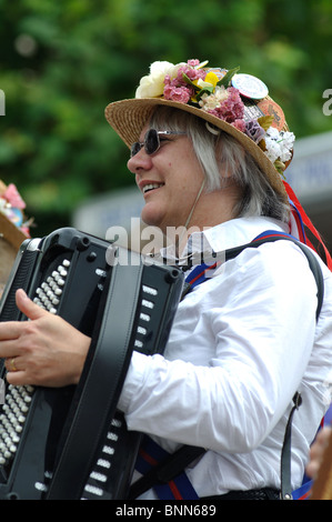 Musician playing the accordion while Morris dancers dance at the ...