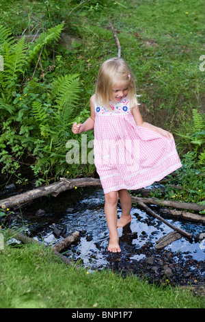 Young girl paddling in a stream, Uk Stock Photo - Alamy