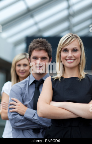 Beautiful businesswoman leading her team with folded arms Stock Photo ...